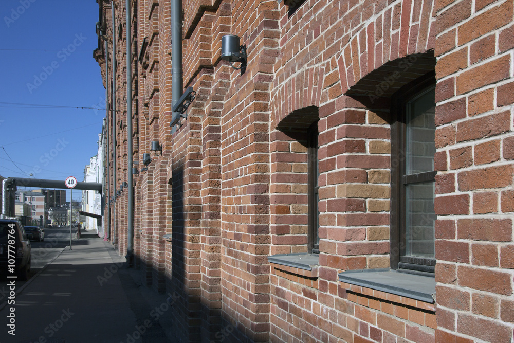 old red brick building in perspective on street of Moscow at sun Stock ...