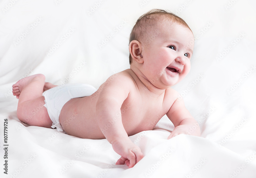 Baby in diaper on a white background with a branch of cotton Stock ...