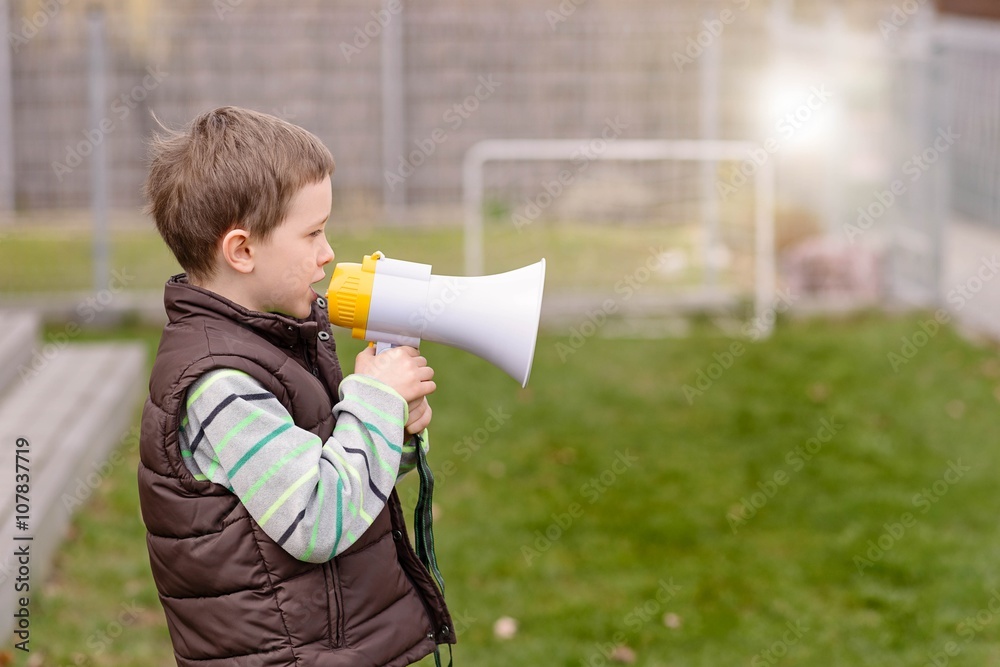 Little boy screaming through a megaphone Stock Photo | Adobe Stock