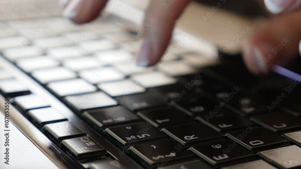 Female fingers typing on black laptop keyboard keys close-up tilting 4K ...