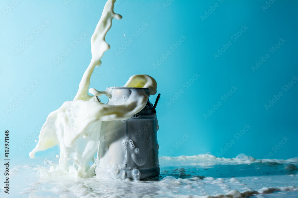 splashes of milk, stream jet of milk pours pouring into a can of milk ...