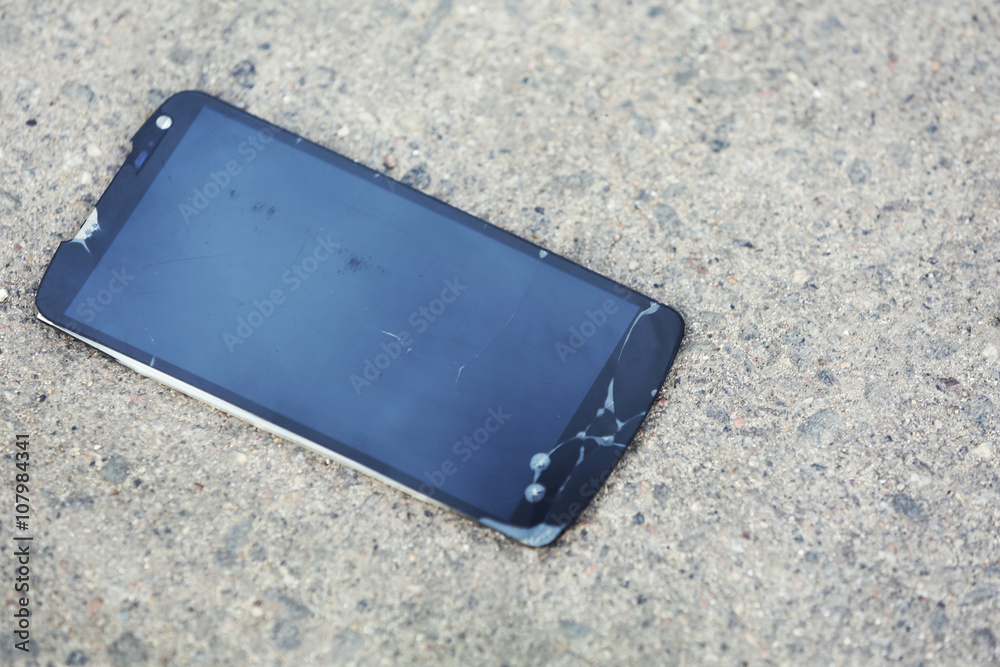 Broken mobile phone with cracked screen on the pavement Stock Photo ...
