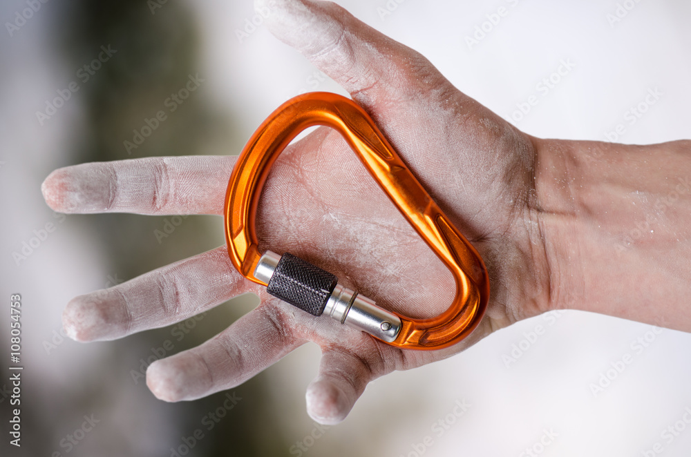 Man´s hand holding a carbine on a rope. Climbing equipment isolated on ...