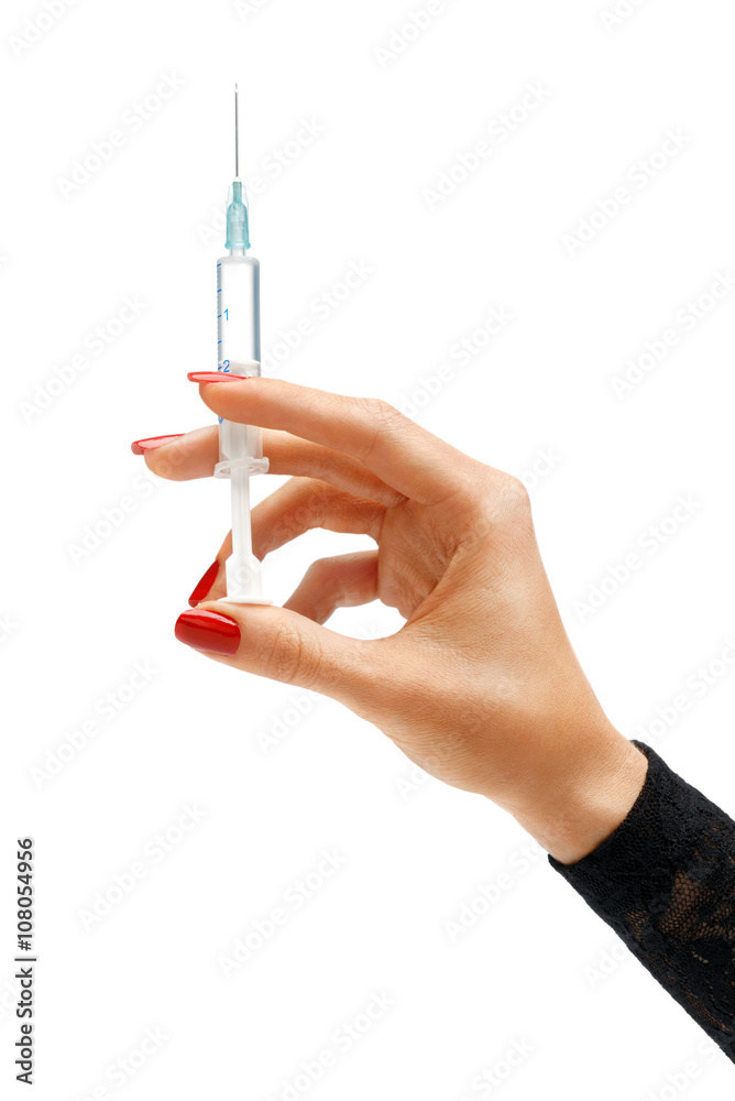 Woman's hand hold a plastic syringe with liquid for chemical at the ...