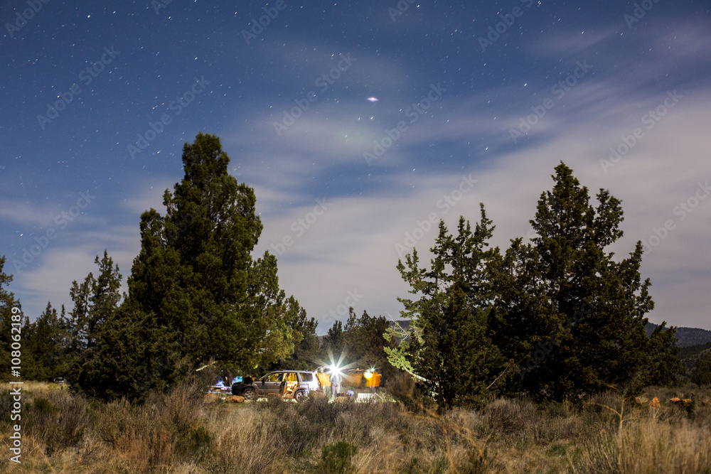 Campsite in remote field under cloudy sky Stock Photo | Adobe Stock