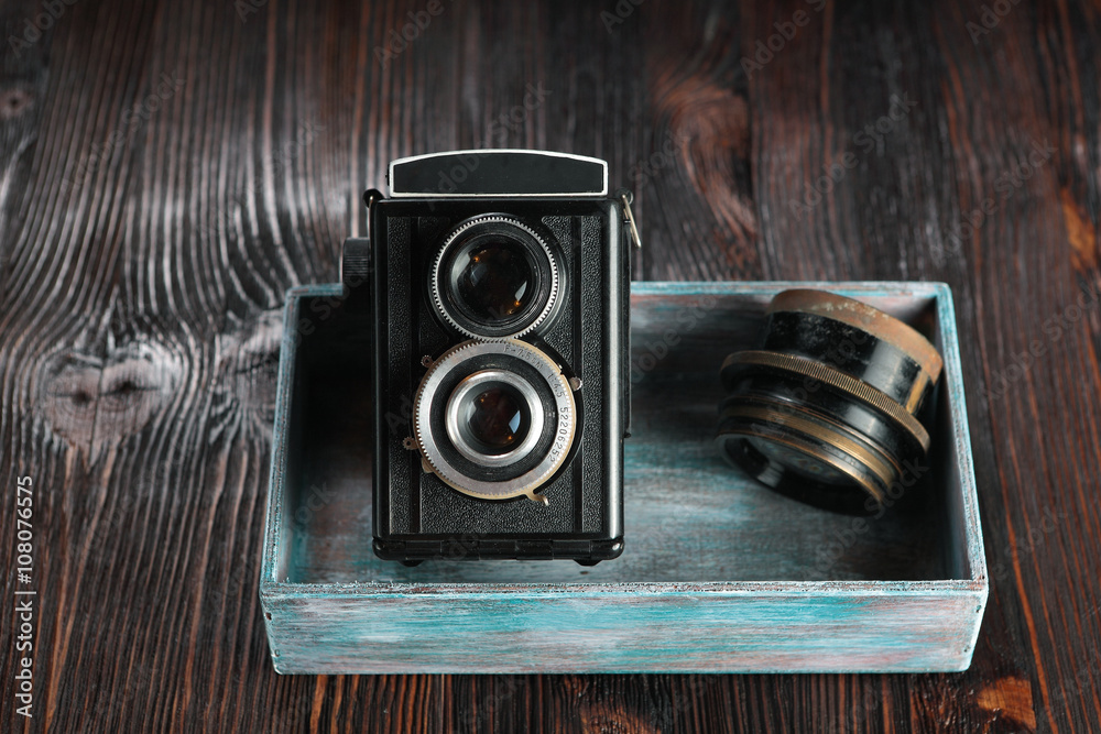 The old film camera and the lens on the wooden table. Stock Photo ...