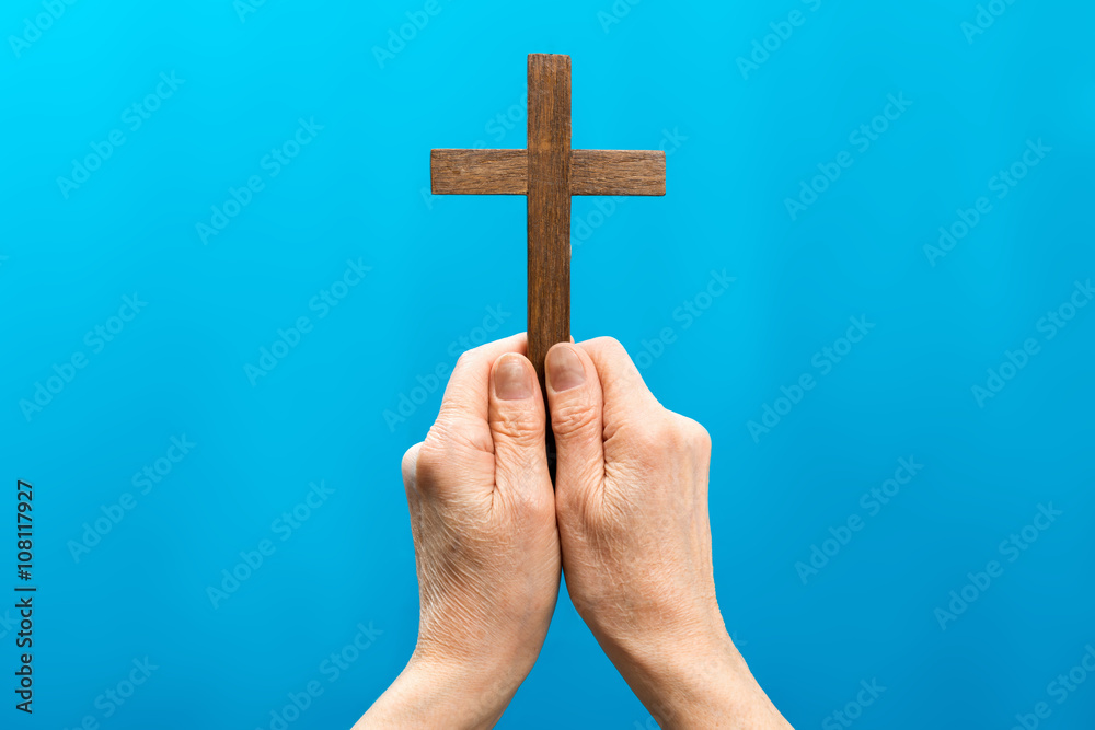 Jesus hand and cross on blue background Stock Photo | Adobe Stock