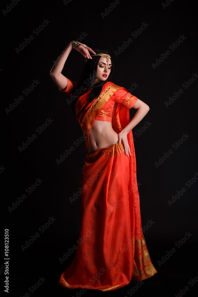 Full body traditional Indian girl in red sari costume standing isolated ...