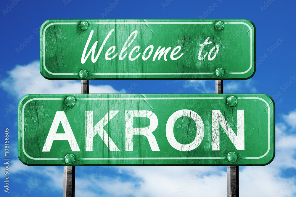 akron vintage green road sign with blue sky background Stock ...