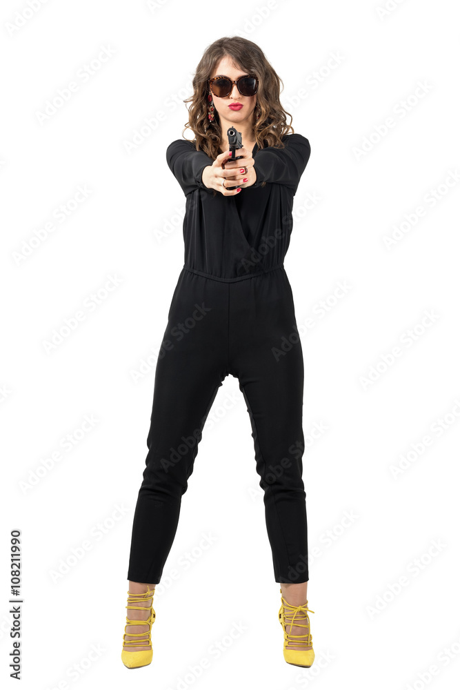 Dangerous mobster woman with sunglasses aiming handgun at camera. Full ...