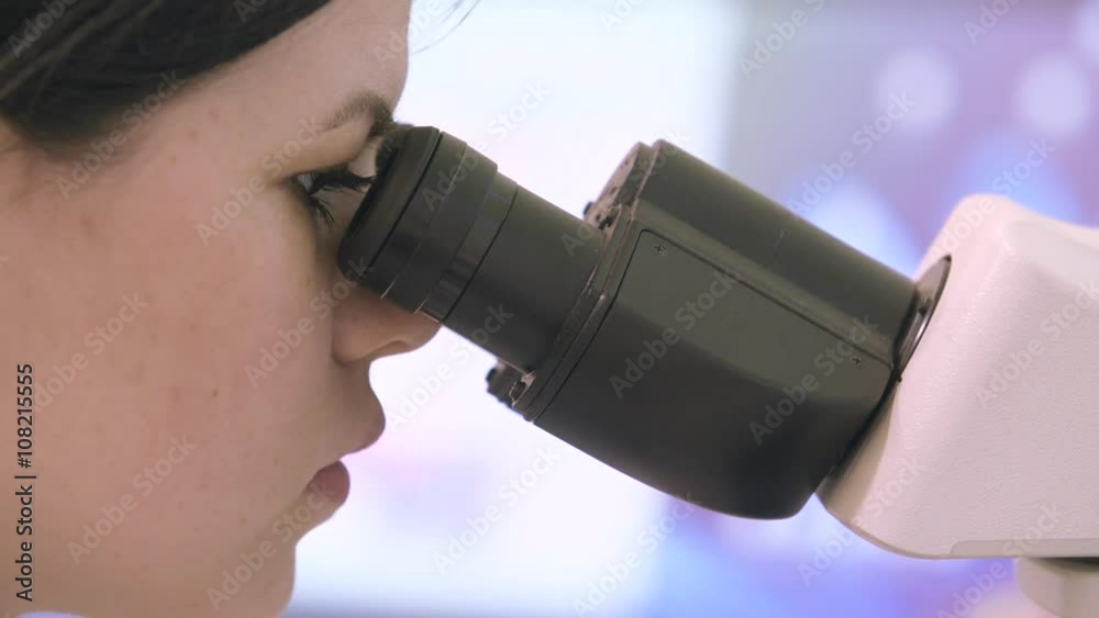 Side view of young doctor looking through microscope Stock Video ...