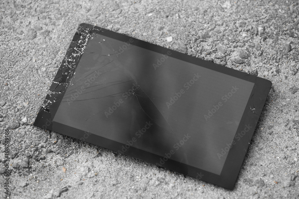 Broken tablet with cracked screen on the pavement Stock Photo | Adobe Stock