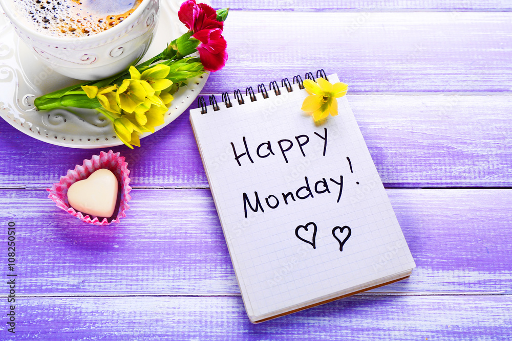 Cup of coffee, chocolate candy, flowers and note HAPPY MONDAY on wooden ...