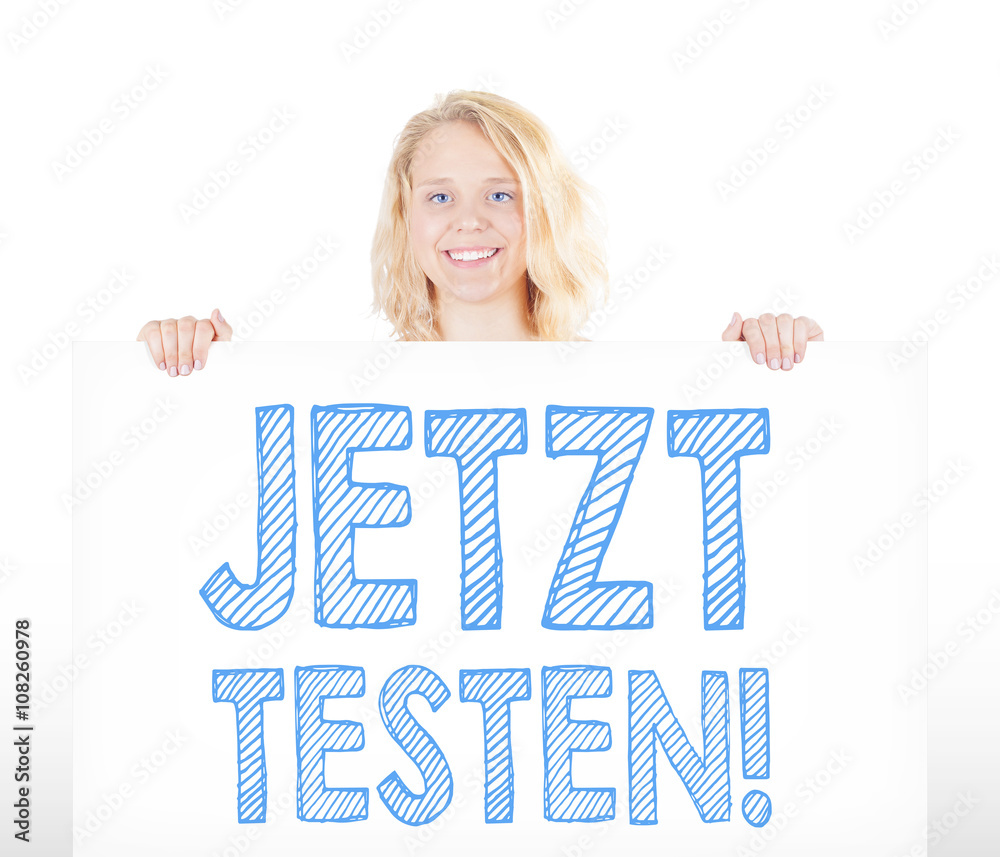 Junge Frau hält Schild mit "Jetzt Testen!" Stock Photo | Adobe Stock