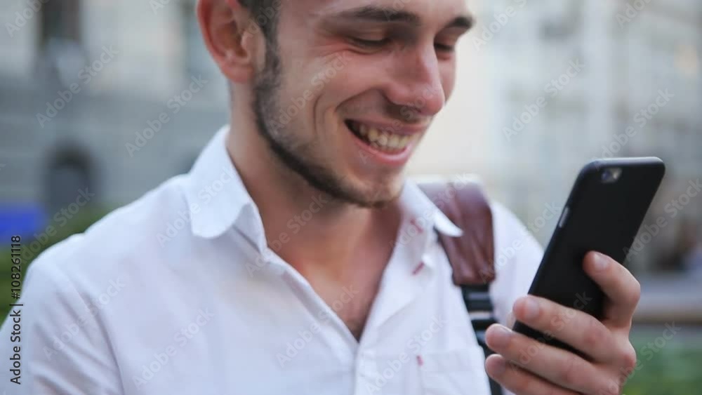 Young male person watching on a phone screen and laughing Stock Video ...