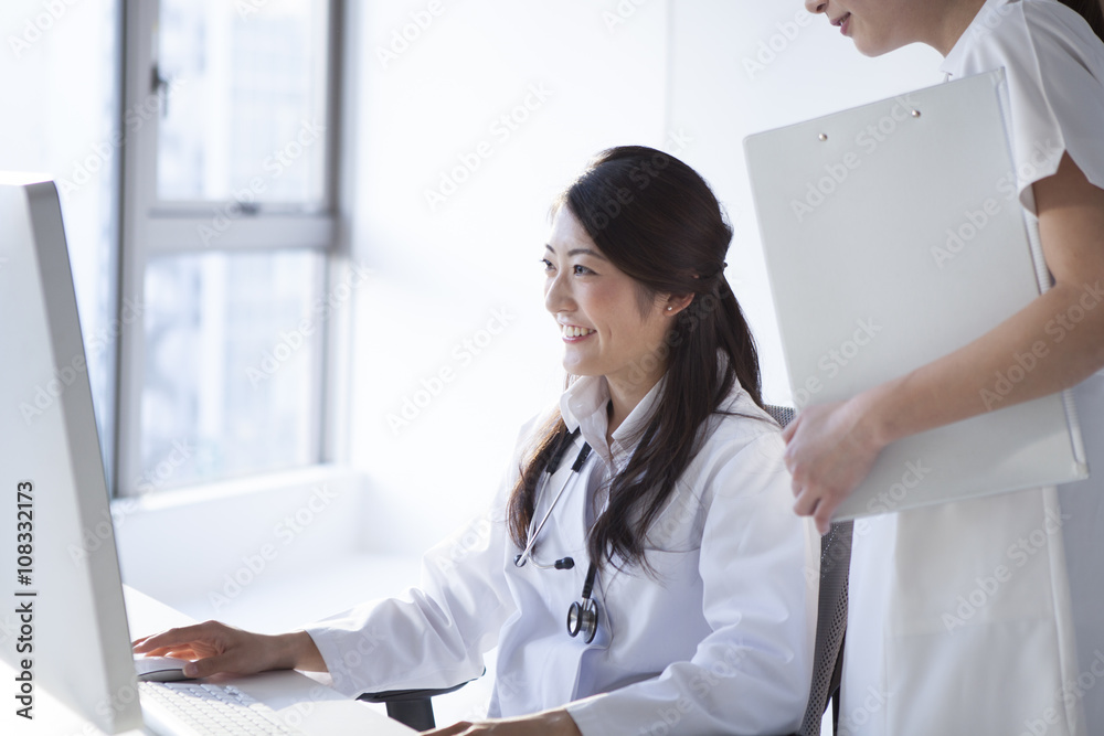 Female doctors and nurses are looking at the screen of a personal ...