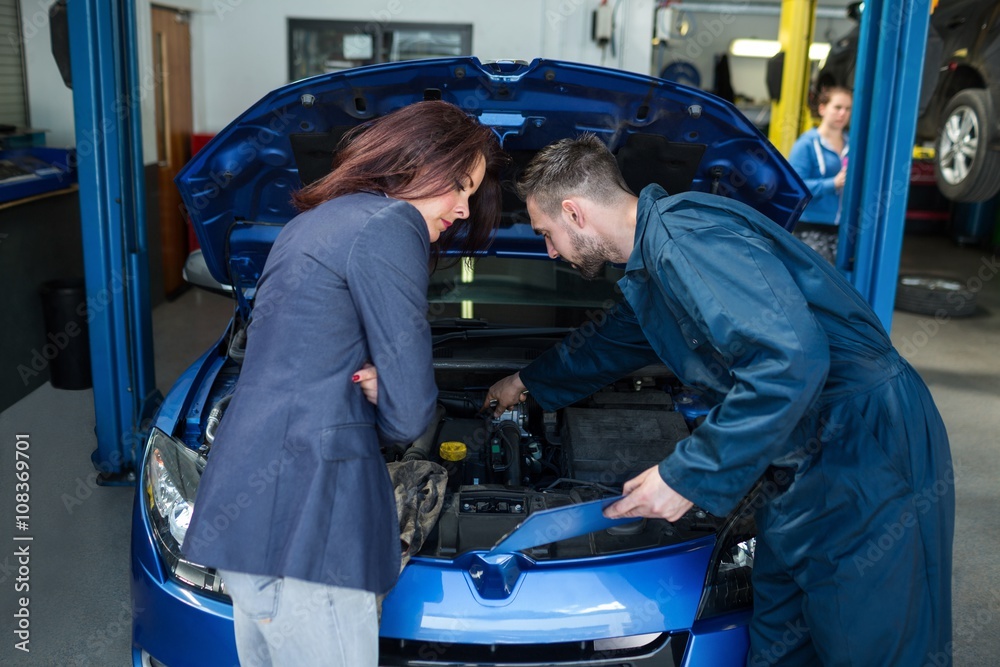 Mechanic showing customer the problem with car Stock Photo | Adobe Stock
