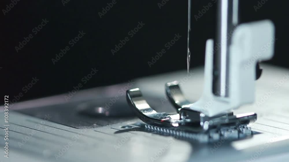 Steel sewing needle in slow motion. Modern sewing machine. Closeup ...