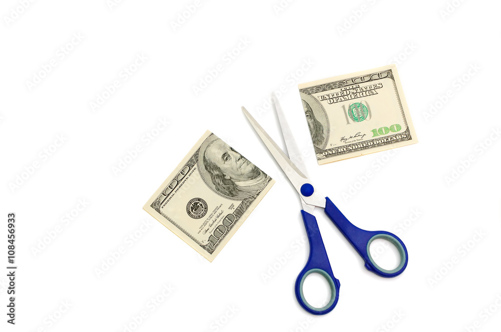 Financial concept. The scissors cutting a banknote on in half. Money on ...