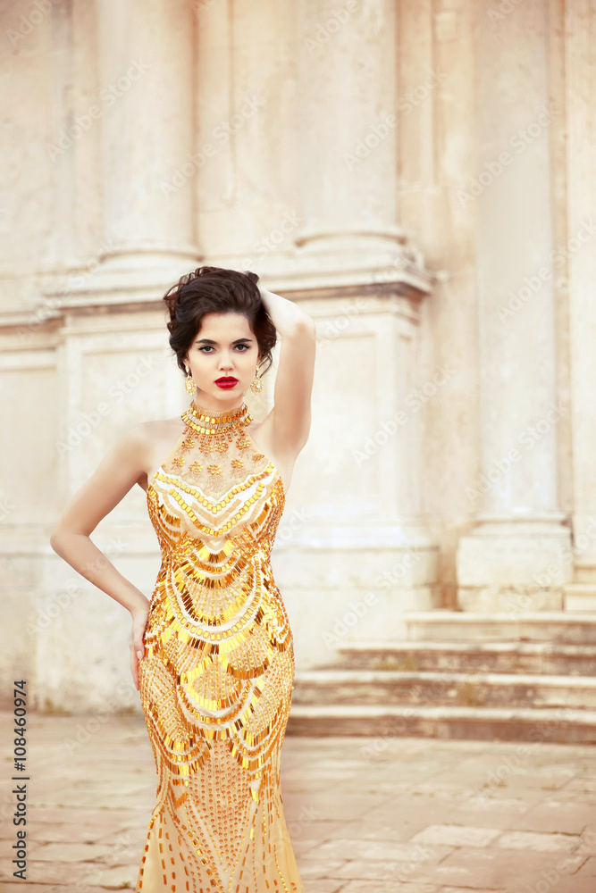 Fashion Model in Gold Dress. Beautiful sexy brunette in elegant Stock ...