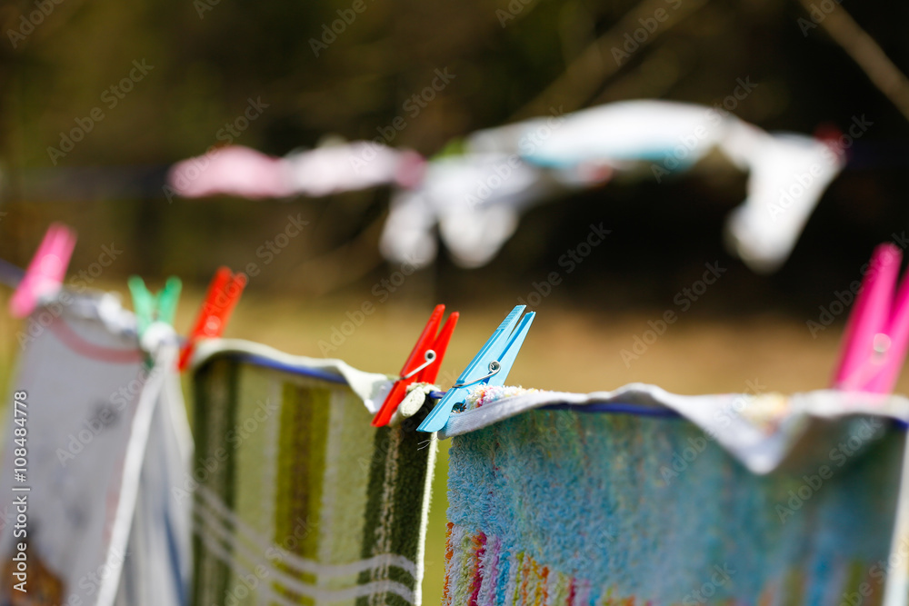 Clothespins holding laundry on the drying line Stock Photo | Adobe Stock