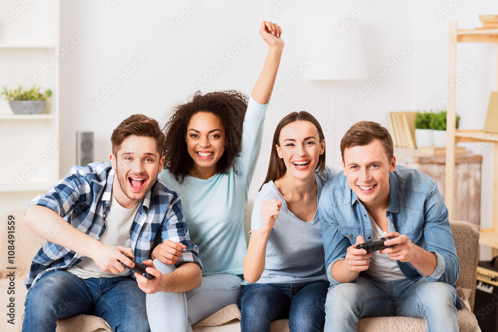 Cheerful friends playing video games Stock Photo | Adobe Stock
