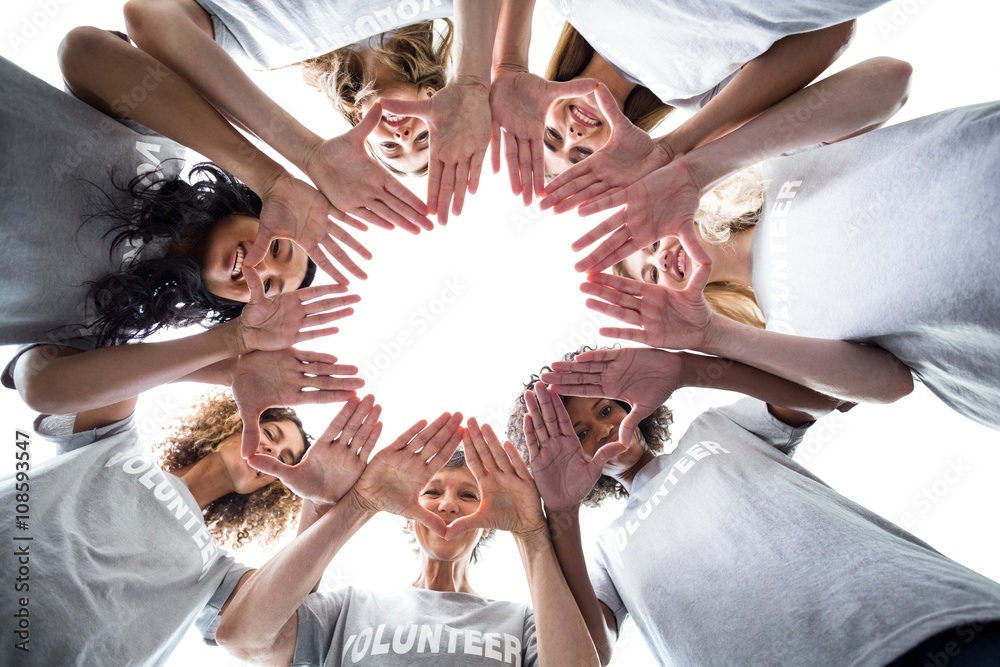 Happy volunteers standing in a circle with their hands together Stock ...
