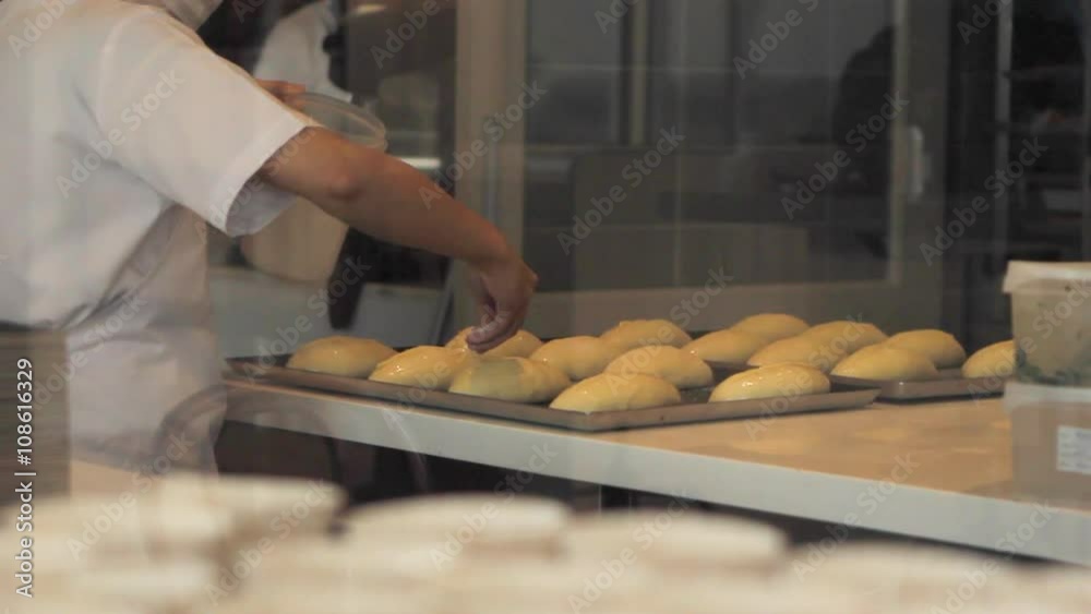 Pastry Chef Dredging Patty Cakes with Sugar / Pastry chef is dredging ...