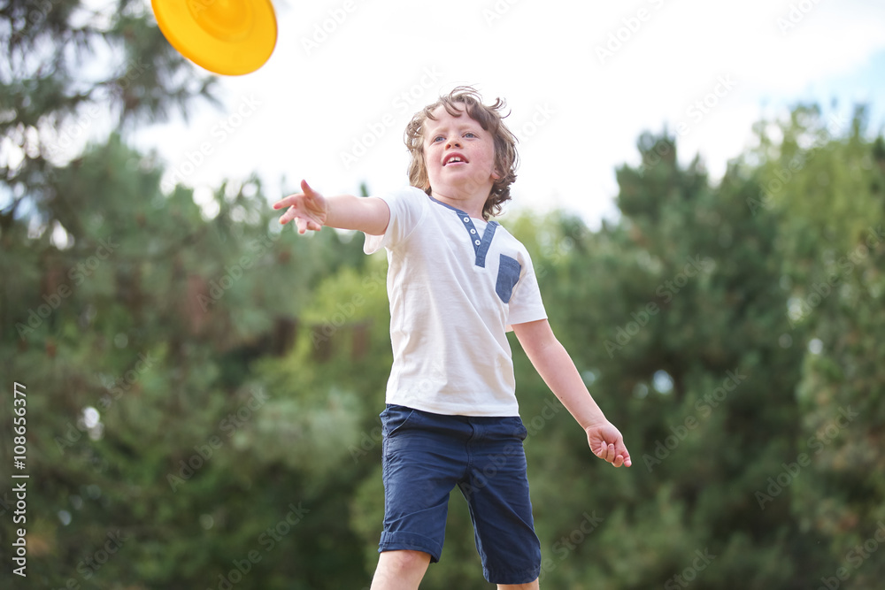 Boy throws frisbee Stock Photo | Adobe Stock