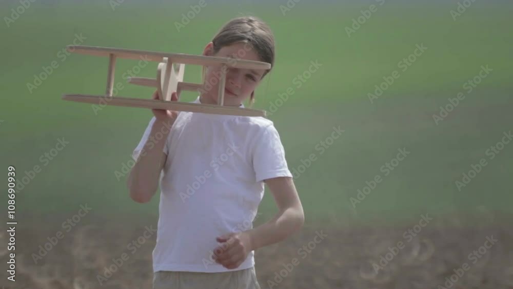 Caucasian boy playing with a model airplane. Portrait of a child with a ...