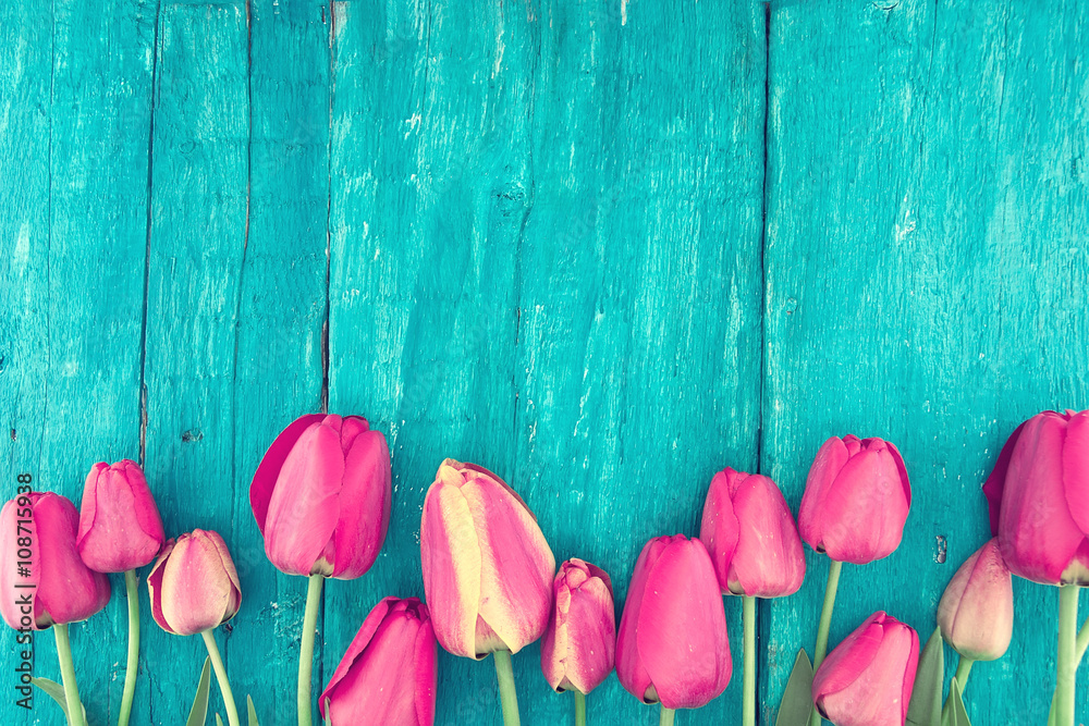 Frame of tulips on turquoise rustic wooden background. Stock Photo ...