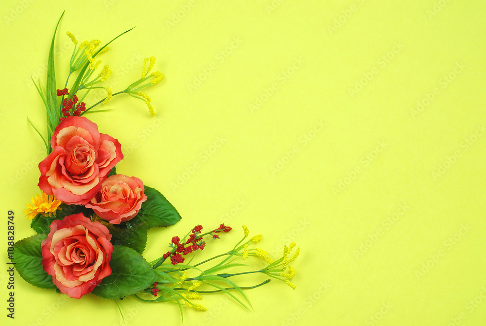 Cheerful silk flowers form a lower left corner border on yellow ...