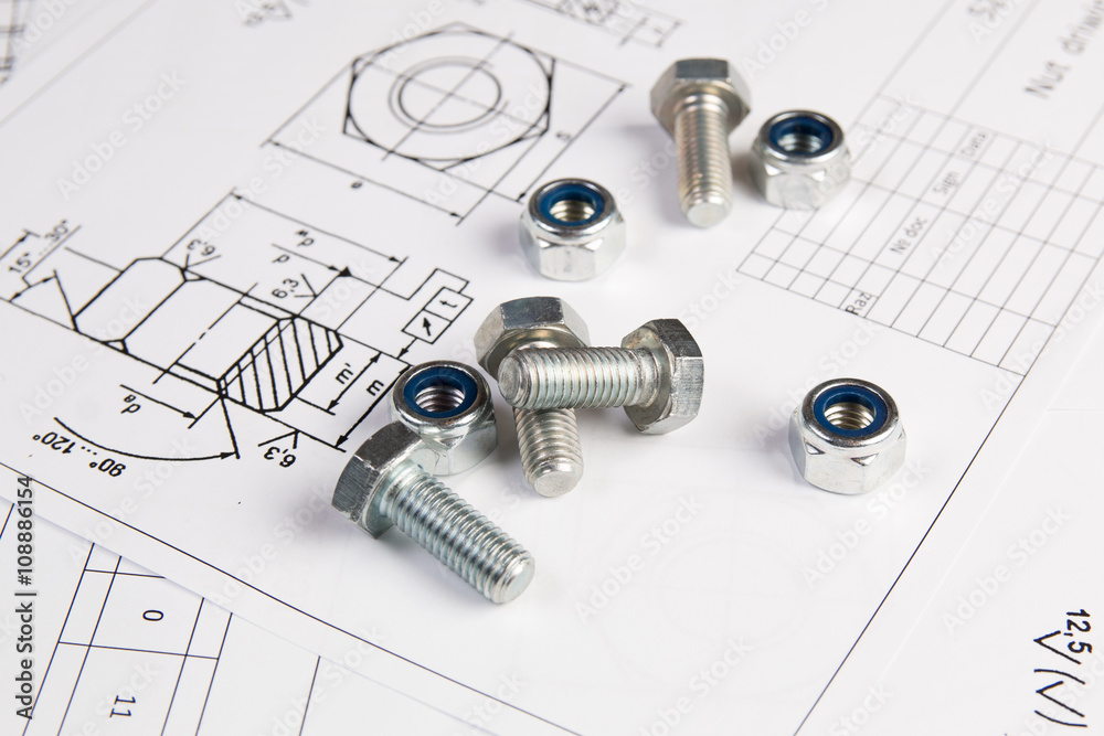Engineering drawings, metal nuts and bolts. Science, mechanics and ...