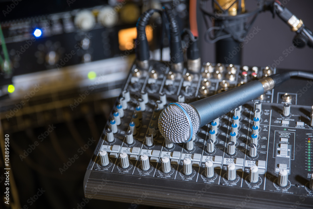 Mixing console and dynamic microphone in recording studio setting ...