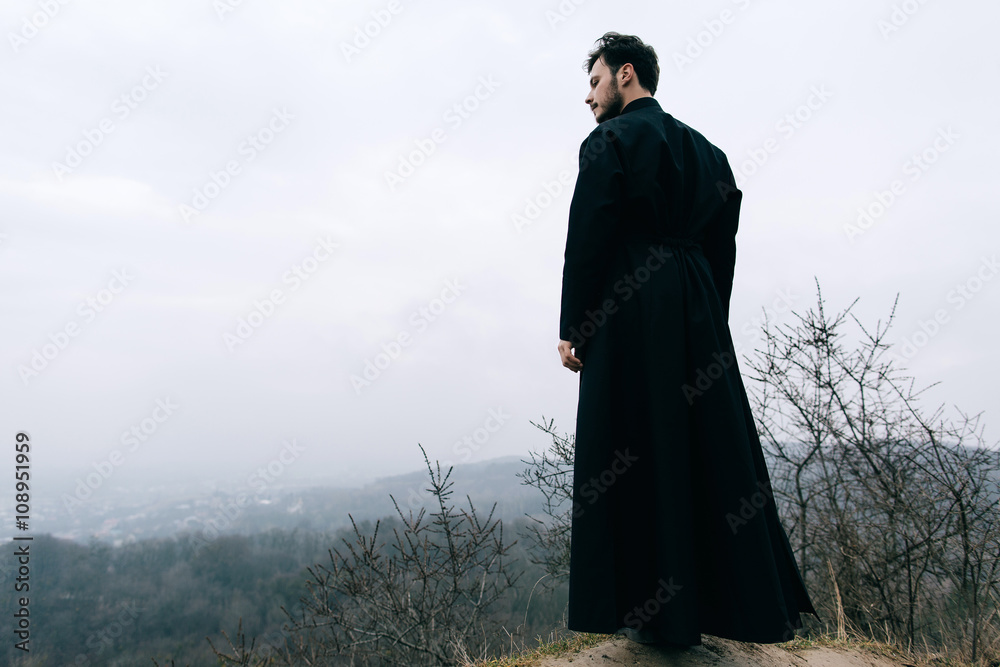 Portrait of handsome catholic bearded man priest or pastor posing ...