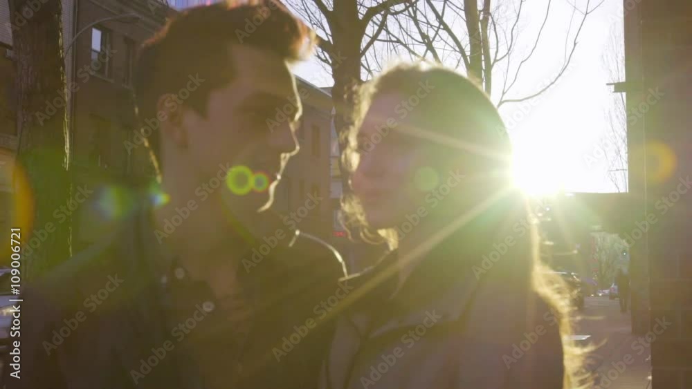 Attractive young man puts arm around beautiful young woman, his date ...
