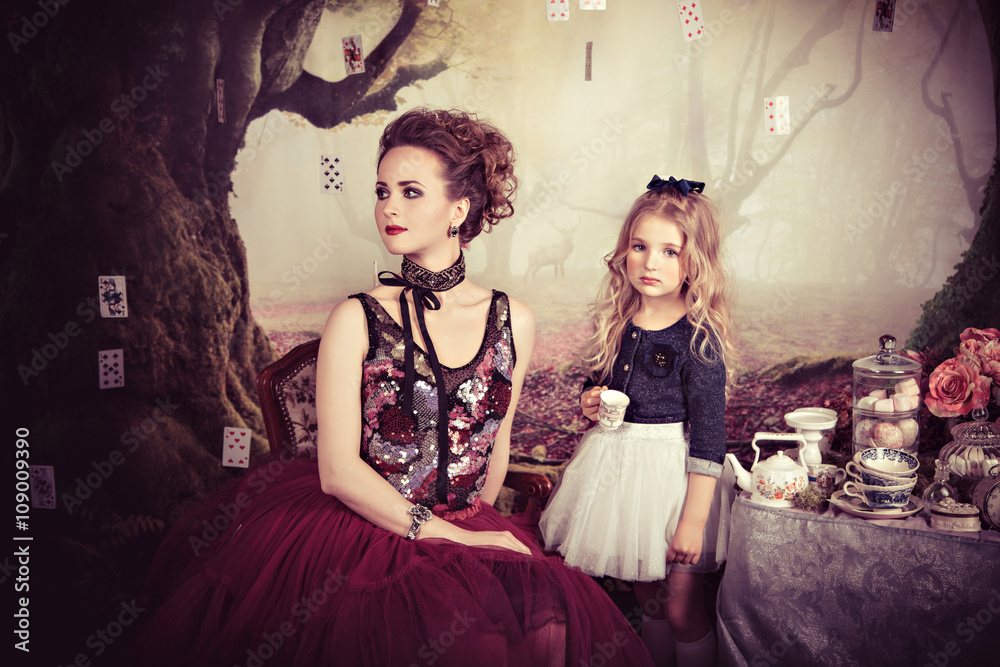 Tea party of Evil Queen and Alice in Wonderland Stock 写真 | Adobe Stock