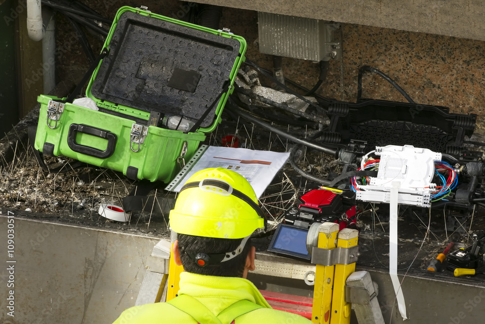 professional electrician worker with safety protective equipment to ...