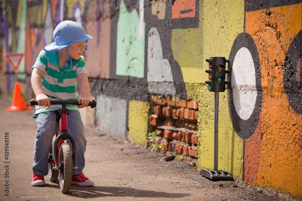 Little kid boy cycling on his bike at special training playground in ...