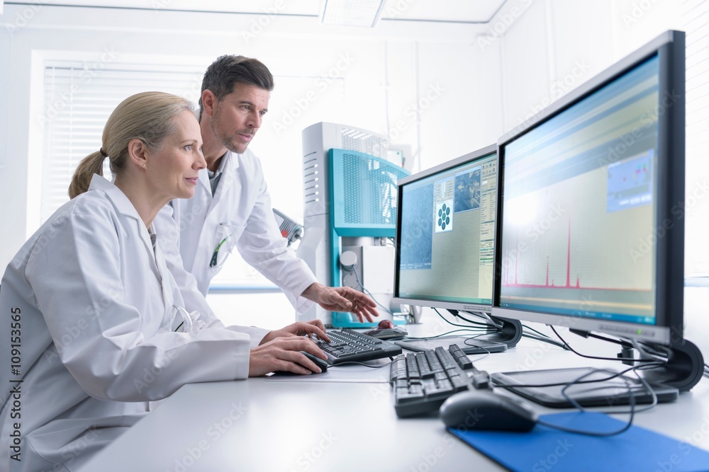 Scientists with electron microscope studying metal structure Stock ...