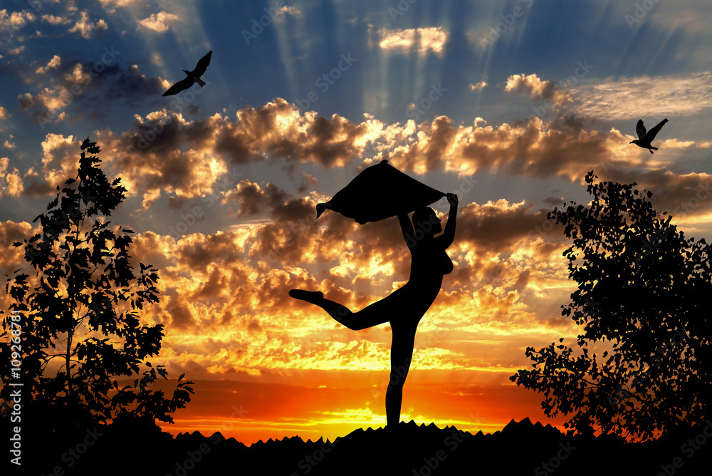 Young girl silhouette with shawl dancing on golden cloudy sunset ...