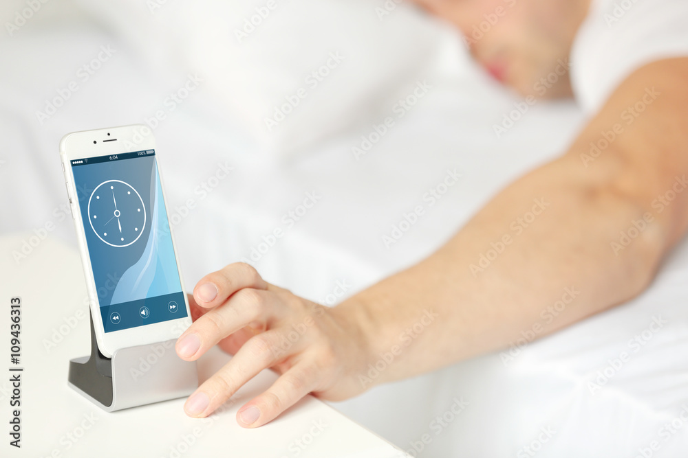 Male hand reaching to a alarm clock Stock Photo | Adobe Stock