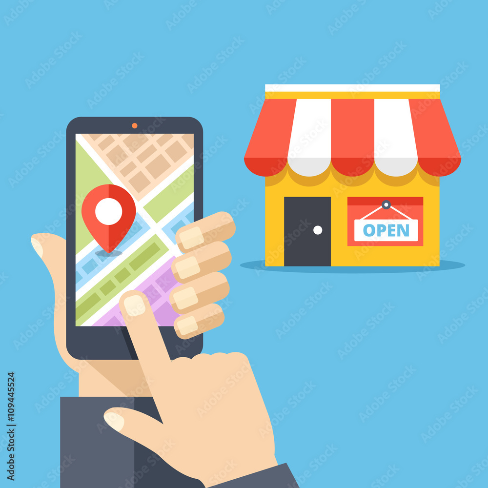 Hand holding smartphone with city map and store location on screen and ...