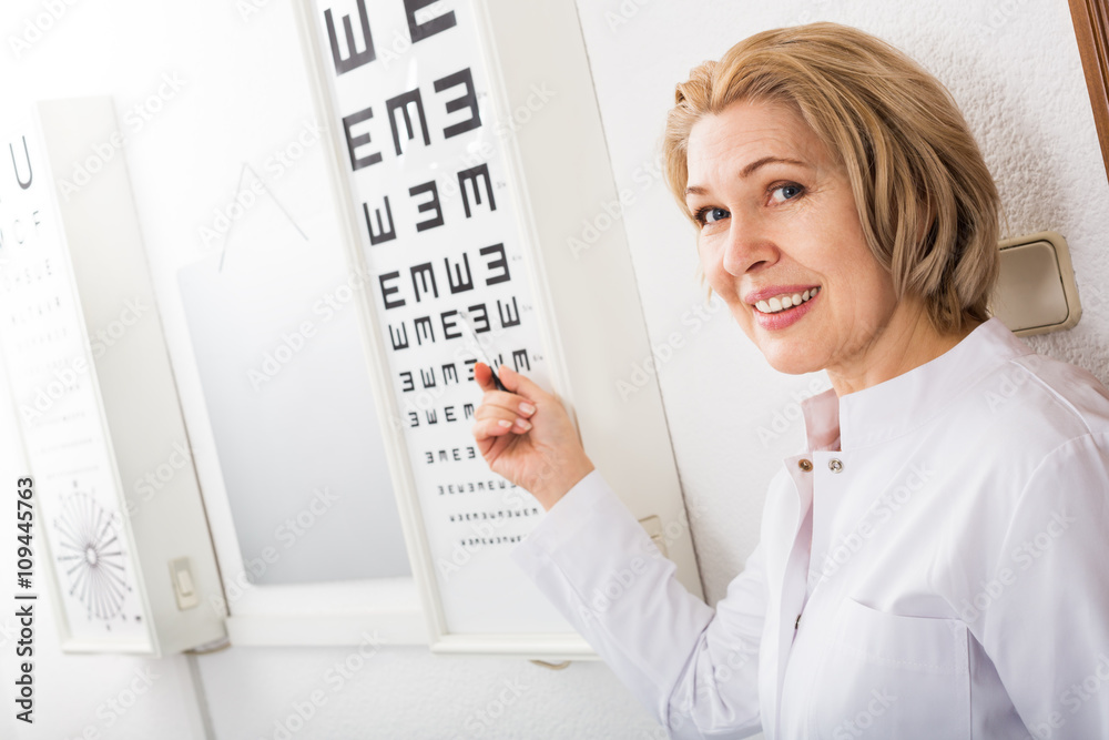 Optician showing symbols of Snellen chart Stock Photo | Adobe Stock