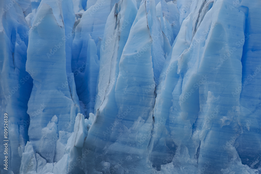 Blue ice cliff of Glacier Grey as it flows into Lago Grey in Torres del ...