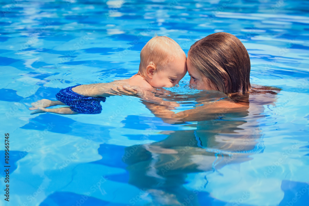 Happy little sports man with mother - active baby swim with fun in ...