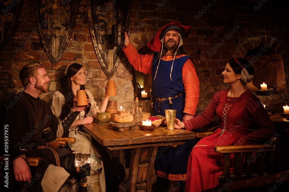 Medieval people eat and drink in ancient castle tavern. Stock Photo ...