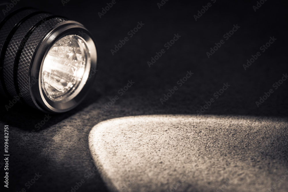 Flashlight and a beam of light in darkness. A modern led light with ...