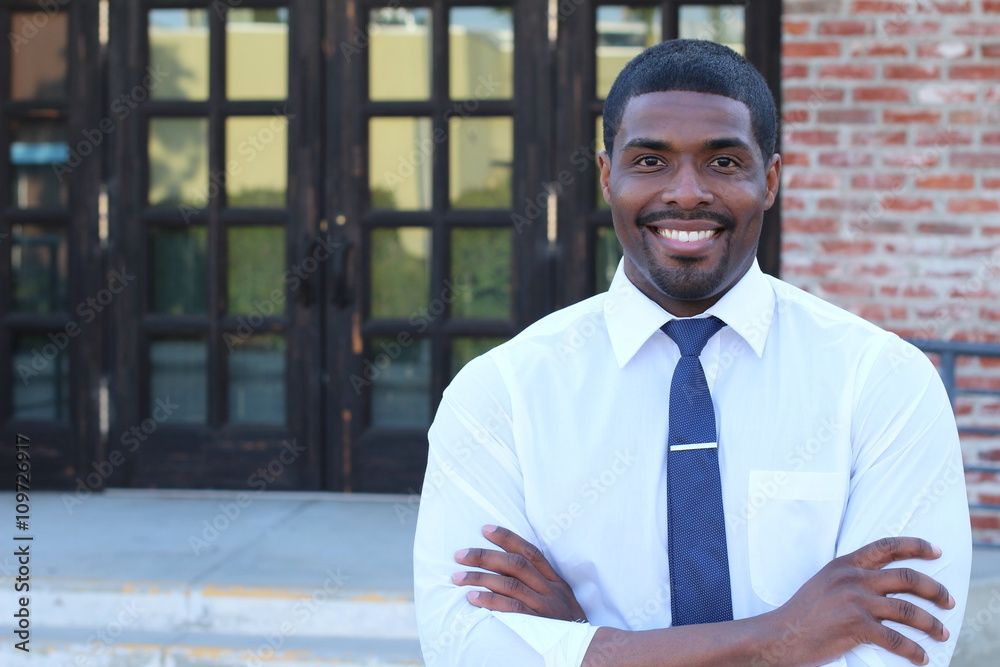 smiling African student or teacher at the entrance of the school ...