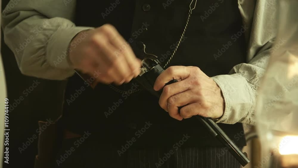 Bullets being loaded into an 1860 army pistol by a gunslinger or ...